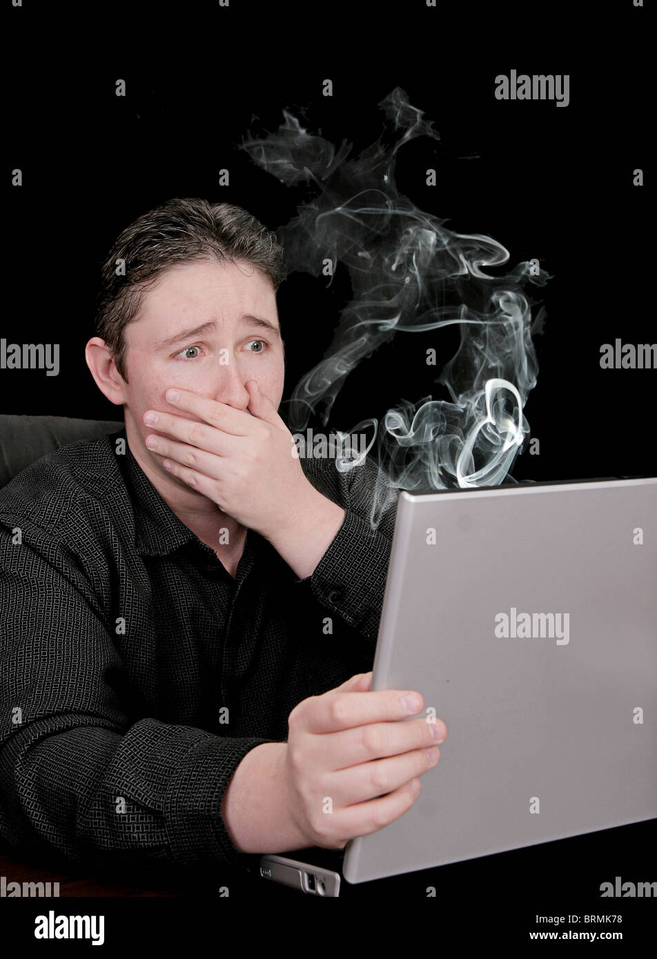 man seeing computer smoke and die is very unhappy Stock Photo - Alamy