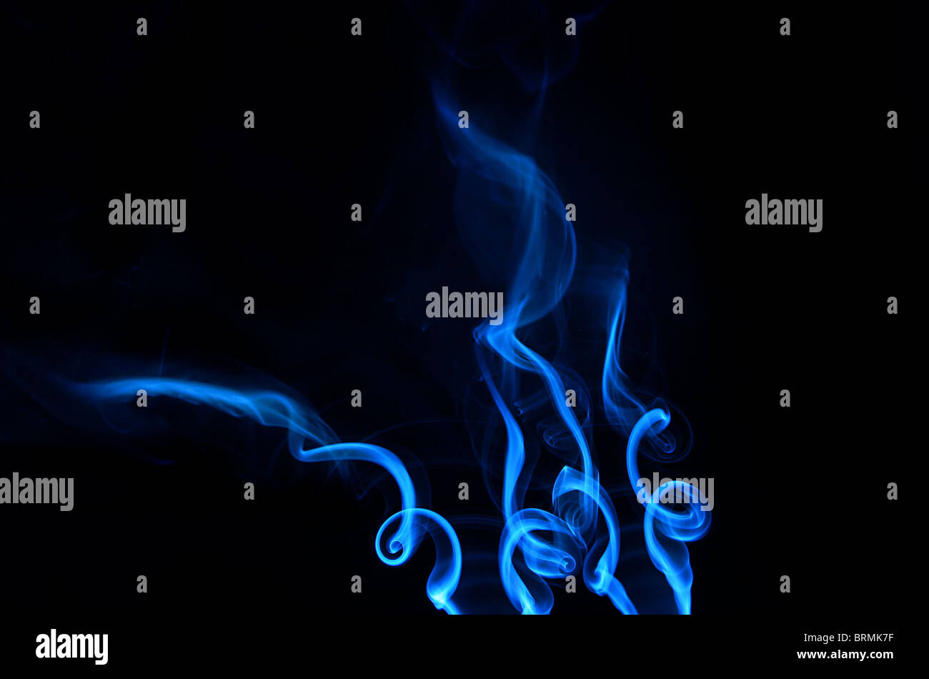 deep blue ethereal smoke trickling upward in spirals Stock Photo - Alamy