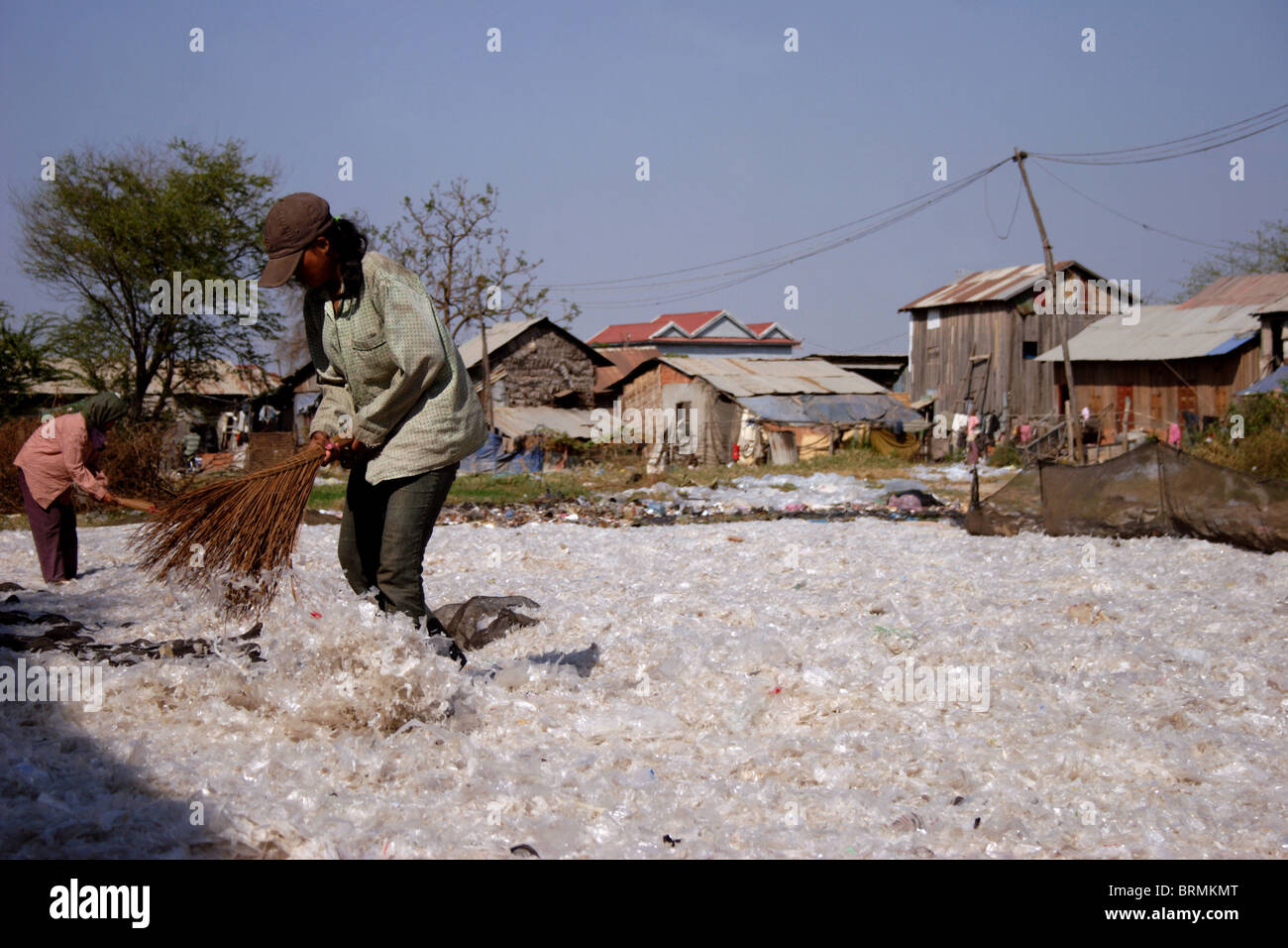 Two women sweep plastic at a recyling facility at The Stung Meanchey ...