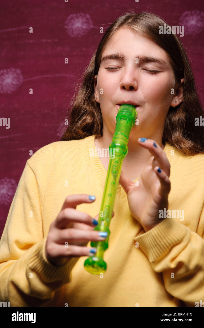 Young girl playing recorder Stock Photo - Alamy