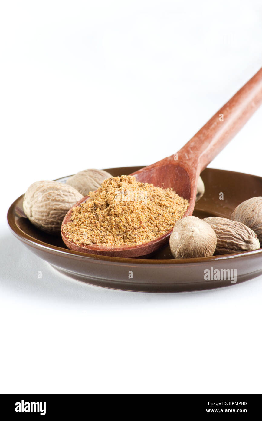 Whole and ground nutmeg on white background Stock Photo - Alamy