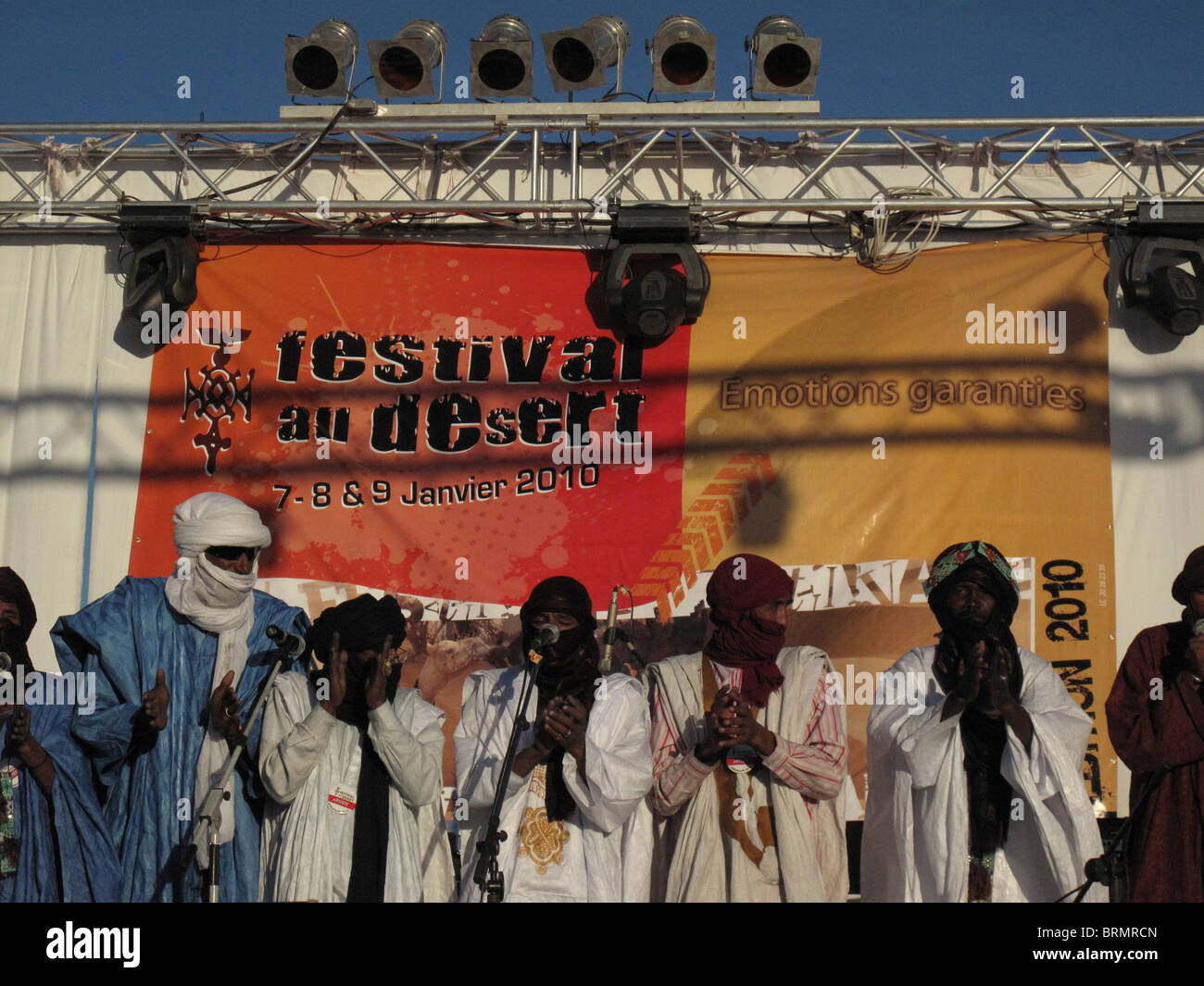 A group of Tuareg men and women on stage at the Festival in the desert ...