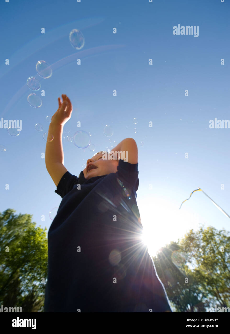 Young boy chasing Stock Photo - Alamy