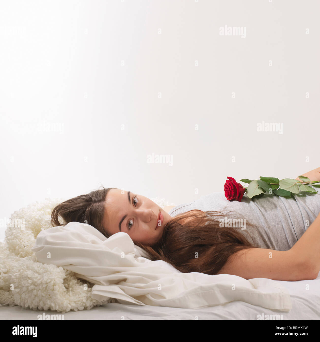 Young woman holding rose bed hi-res stock photography and images - Alamy