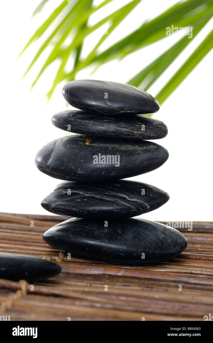 Spa pebbles with palm leaf Stock Photo - Alamy