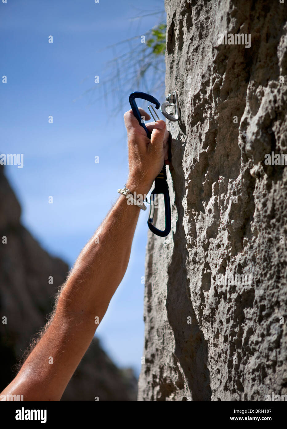 Rock climber securing himself Stock Photo - Alamy