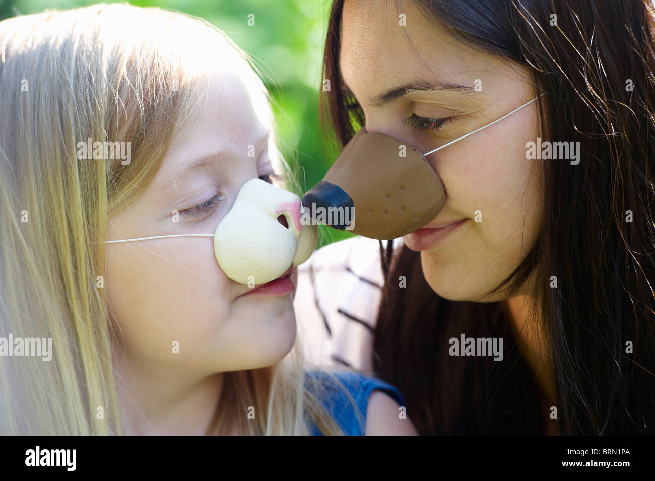 Mother and daughter wearing masks Stock Photo - Alamy
