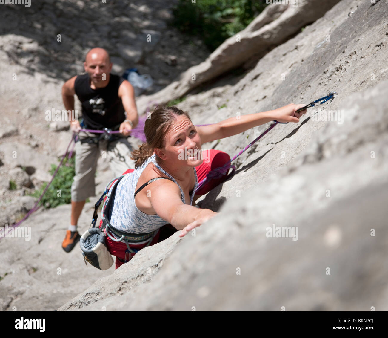 Rock climber climbing rock face Stock Photo - Alamy