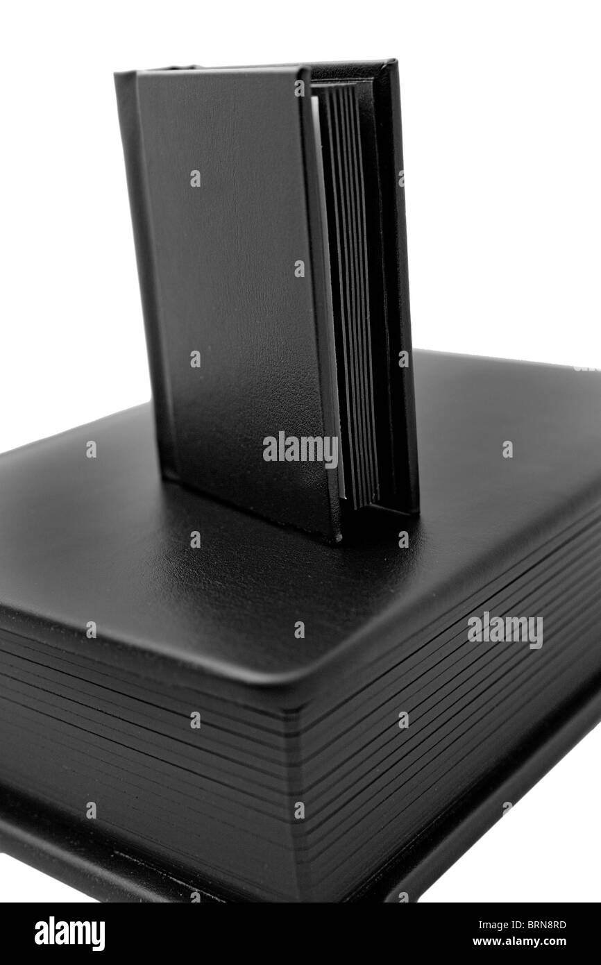 one large and one small black matching books Stock Photo - Alamy