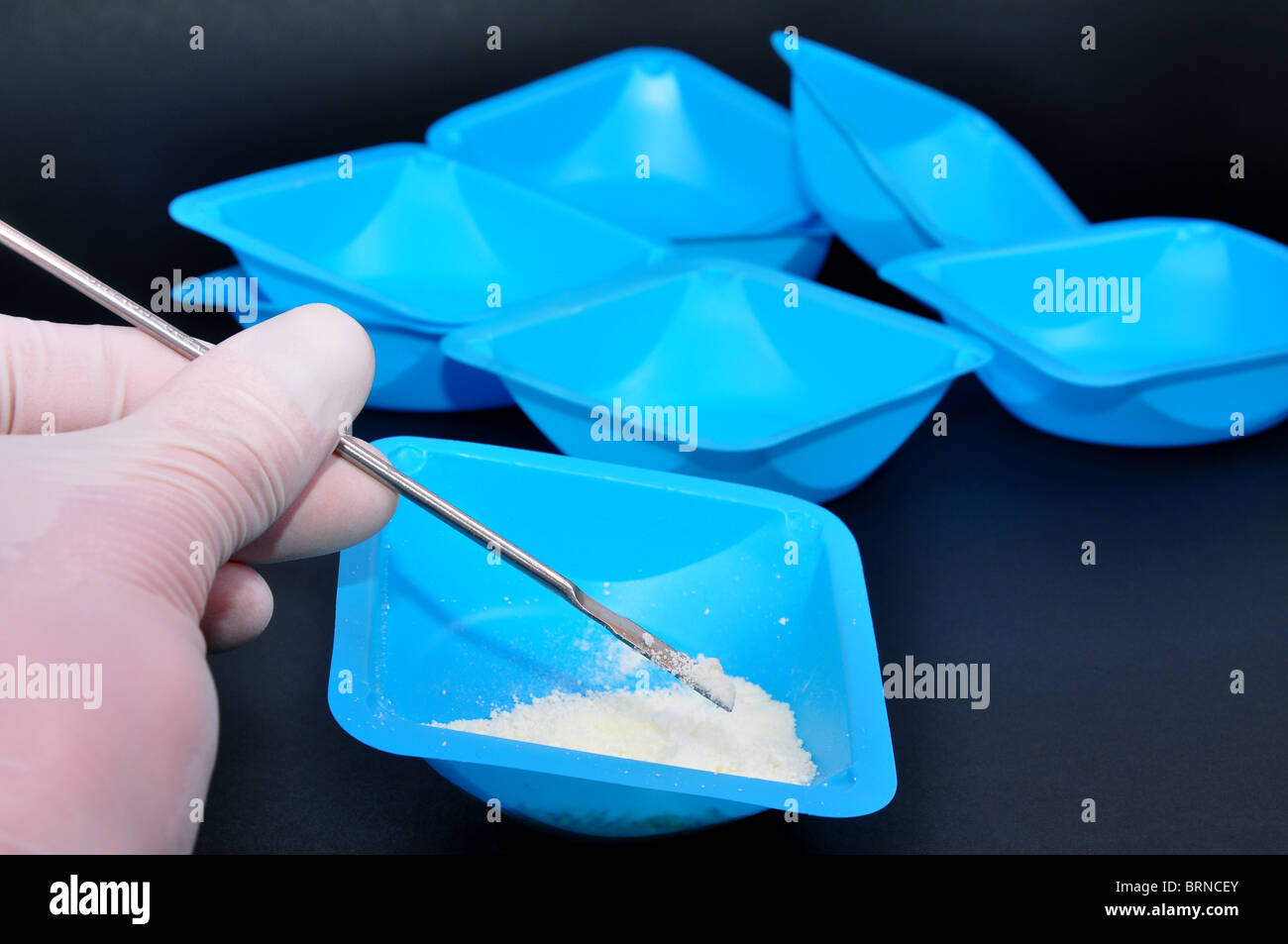 New drug in powder, in a blue container Stock Photo - Alamy
