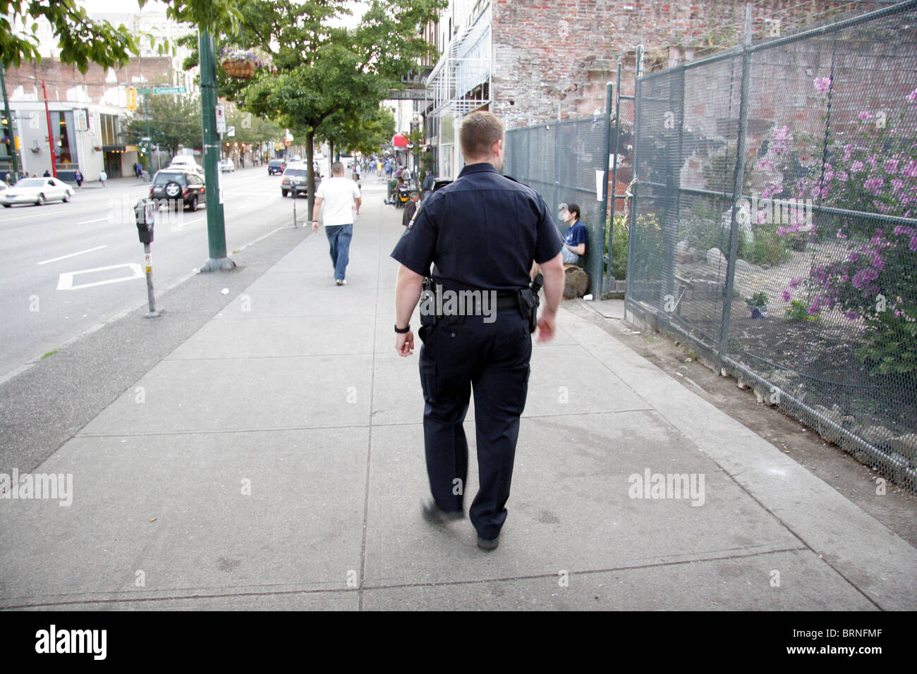 Police officer on foot patrol in East Hastings, Vancouver, Canada Stock ...