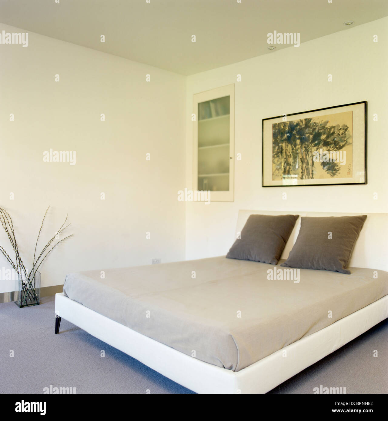 Minimalist bedroom with large picture above modern bed with brown ...