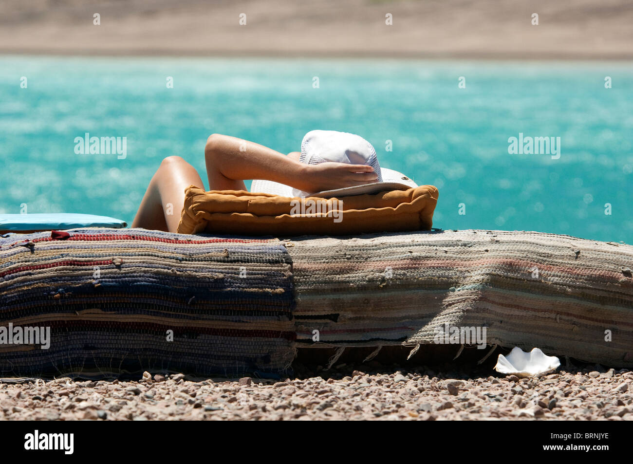Old woman sunbathing on beach hi-res stock photography and images - Alamy