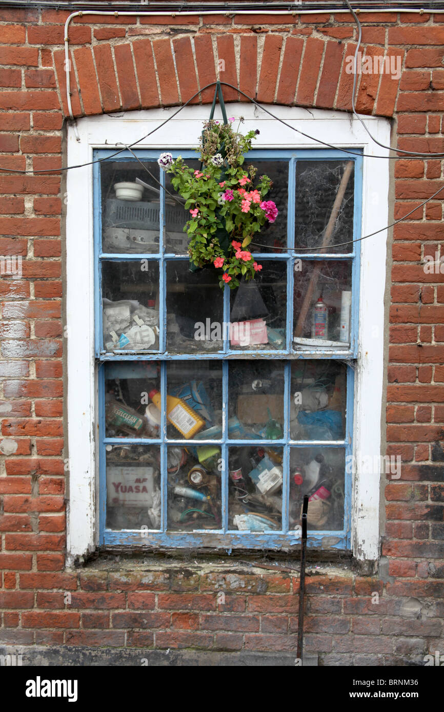 Photograph of a window stuffed with junk Stock Photo - Alamy