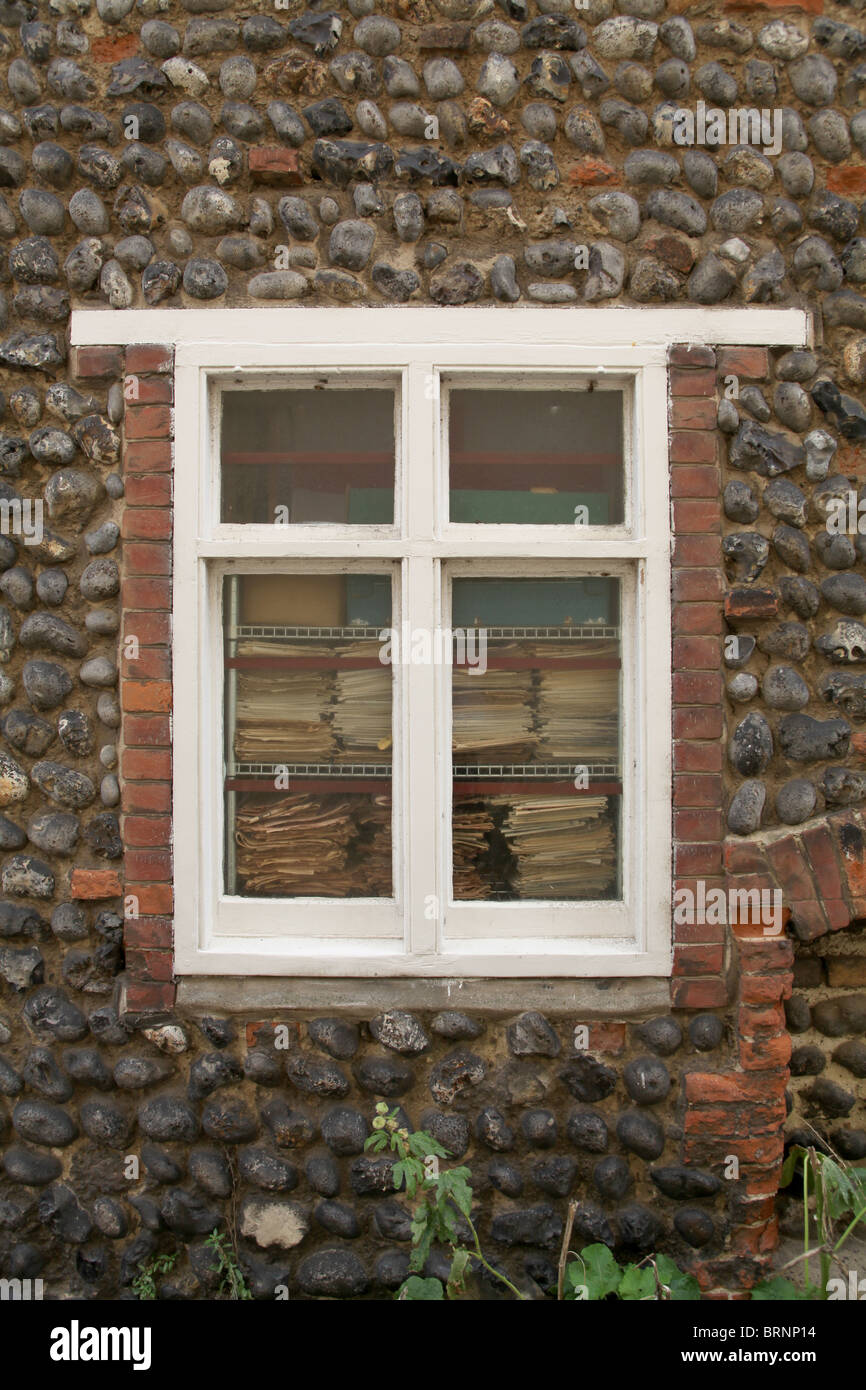 A photograph of a window stuffed with books Stock Photo - Alamy