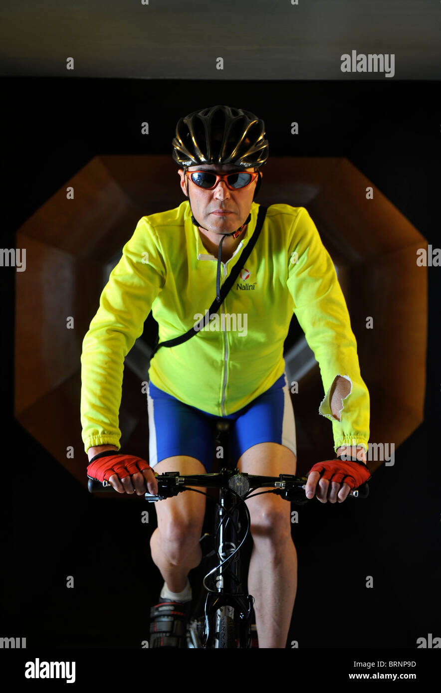 A test cyclist rides a road bike in a wind tunnel experiment for ...