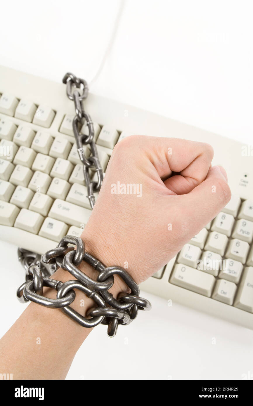 Hand had been Tied Up by chain with Computer Keyboard Stock Photo - Alamy