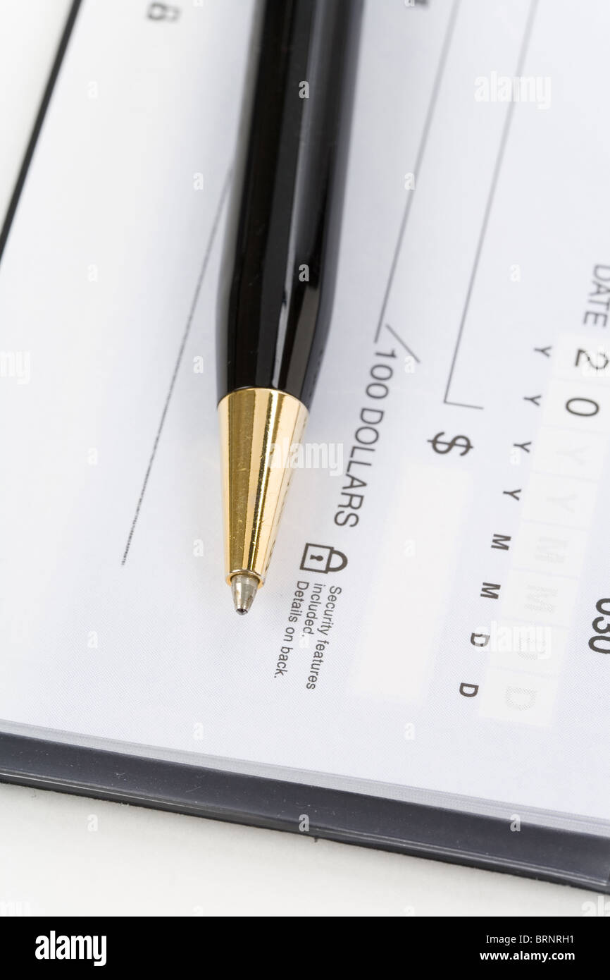 Checkbook and pen close up Stock Photo - Alamy