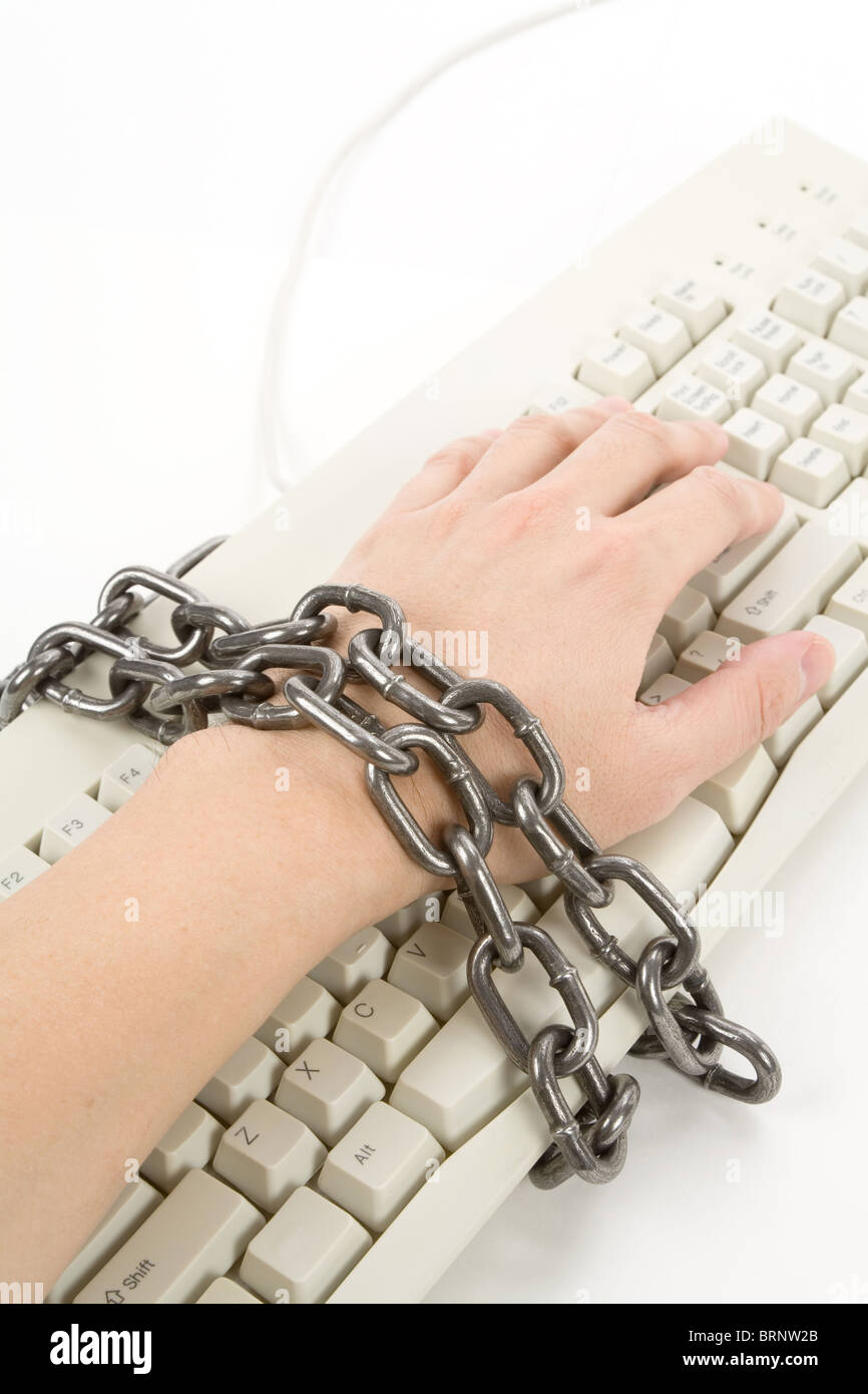 Hand had been Tied Up by chain with Computer Keyboard Stock Photo - Alamy