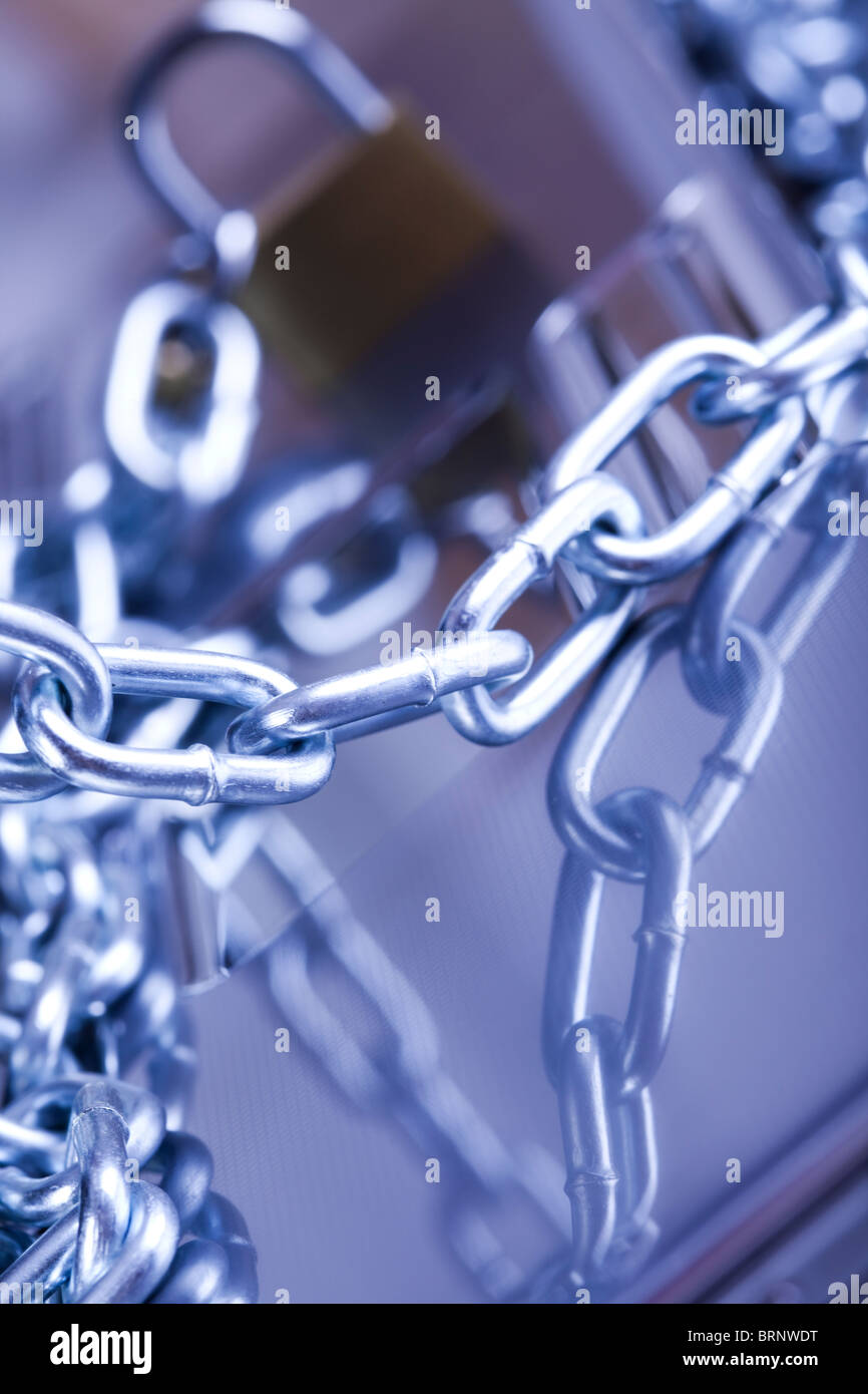 Laptop with chains Stock Photo - Alamy