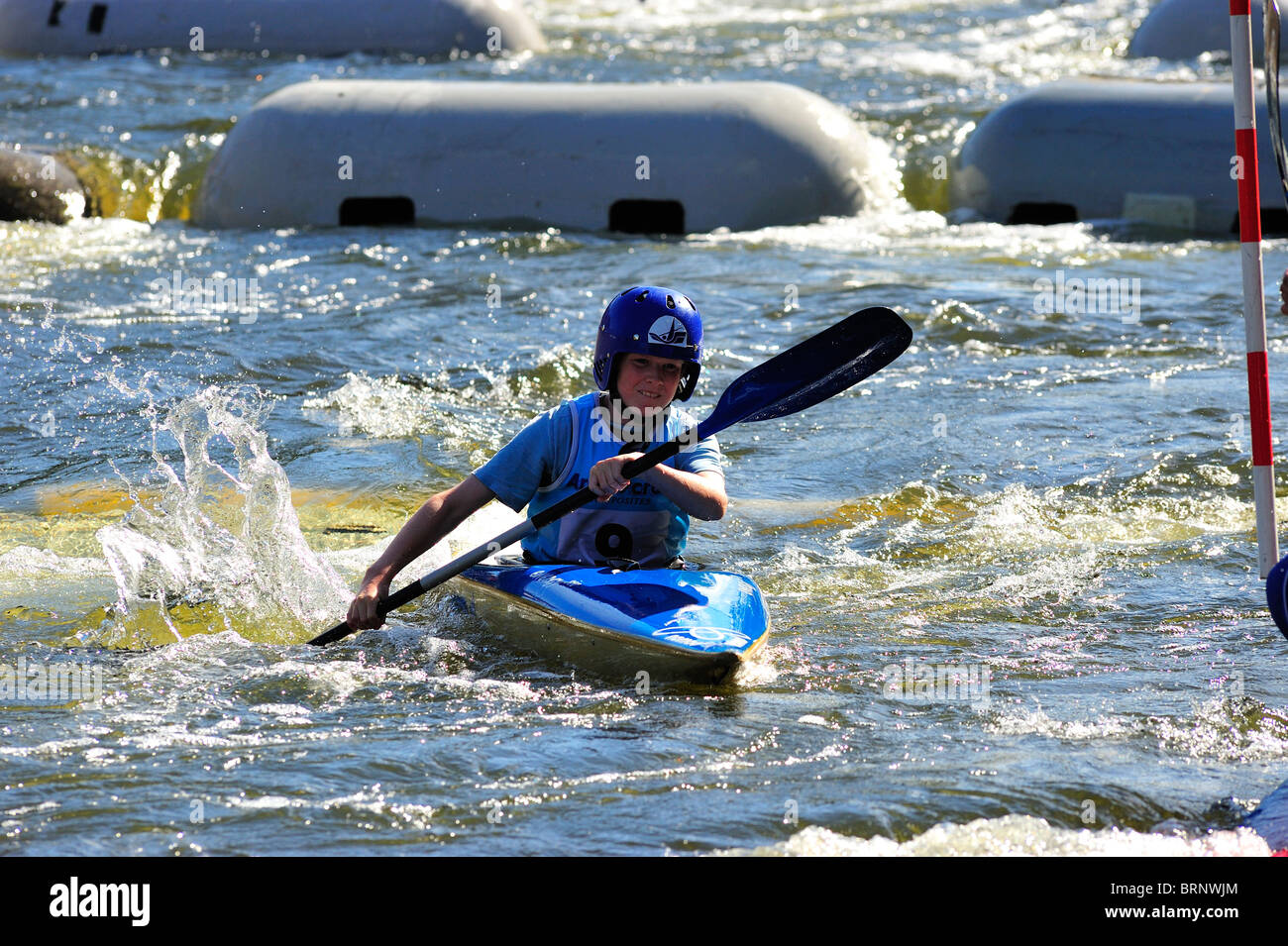 Young boy competing in canoe slalom competition in Bedford, england ...