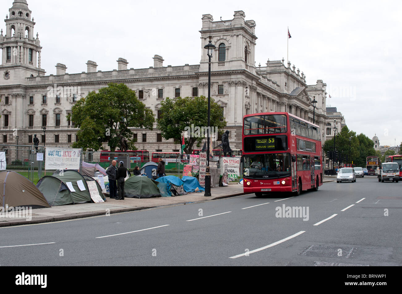Red London Bus drives past peace protesters from the "peace strike ...