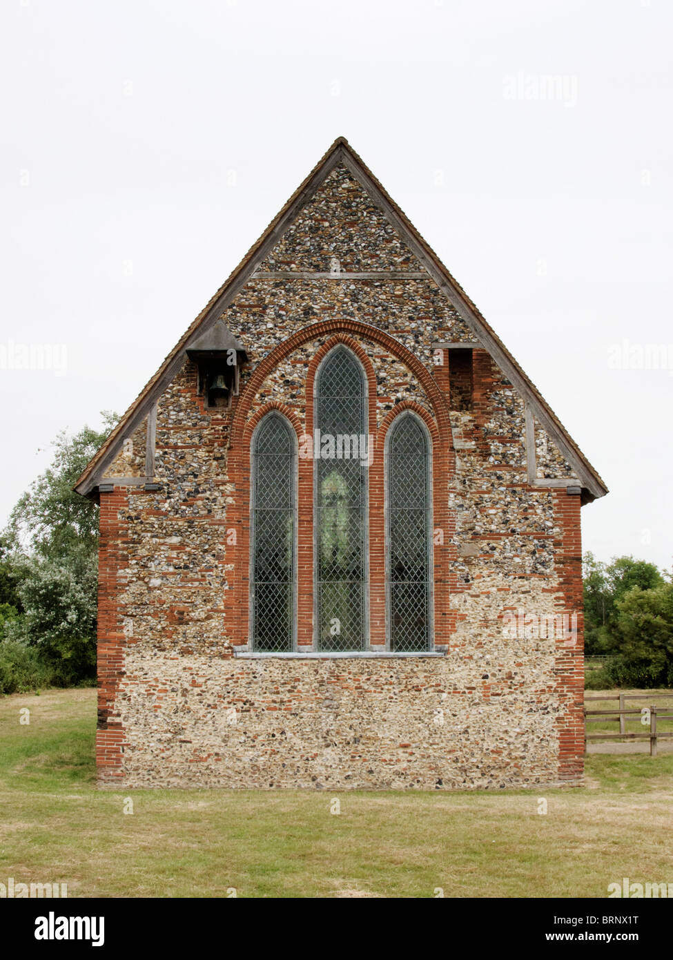 small old stone chapel back end view of St Nicholas' Chapel in essex uk ...