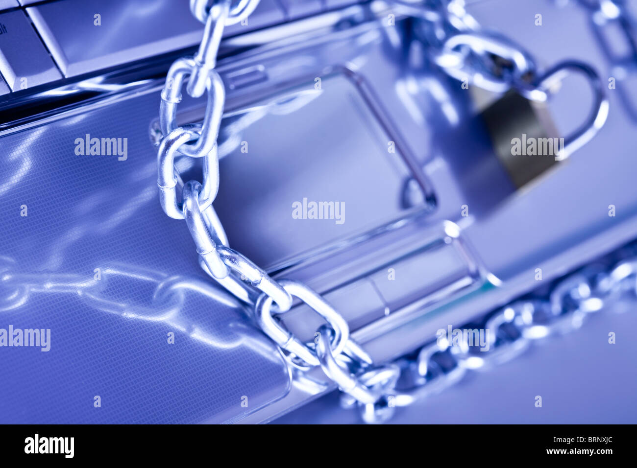 Laptop with chains Stock Photo - Alamy