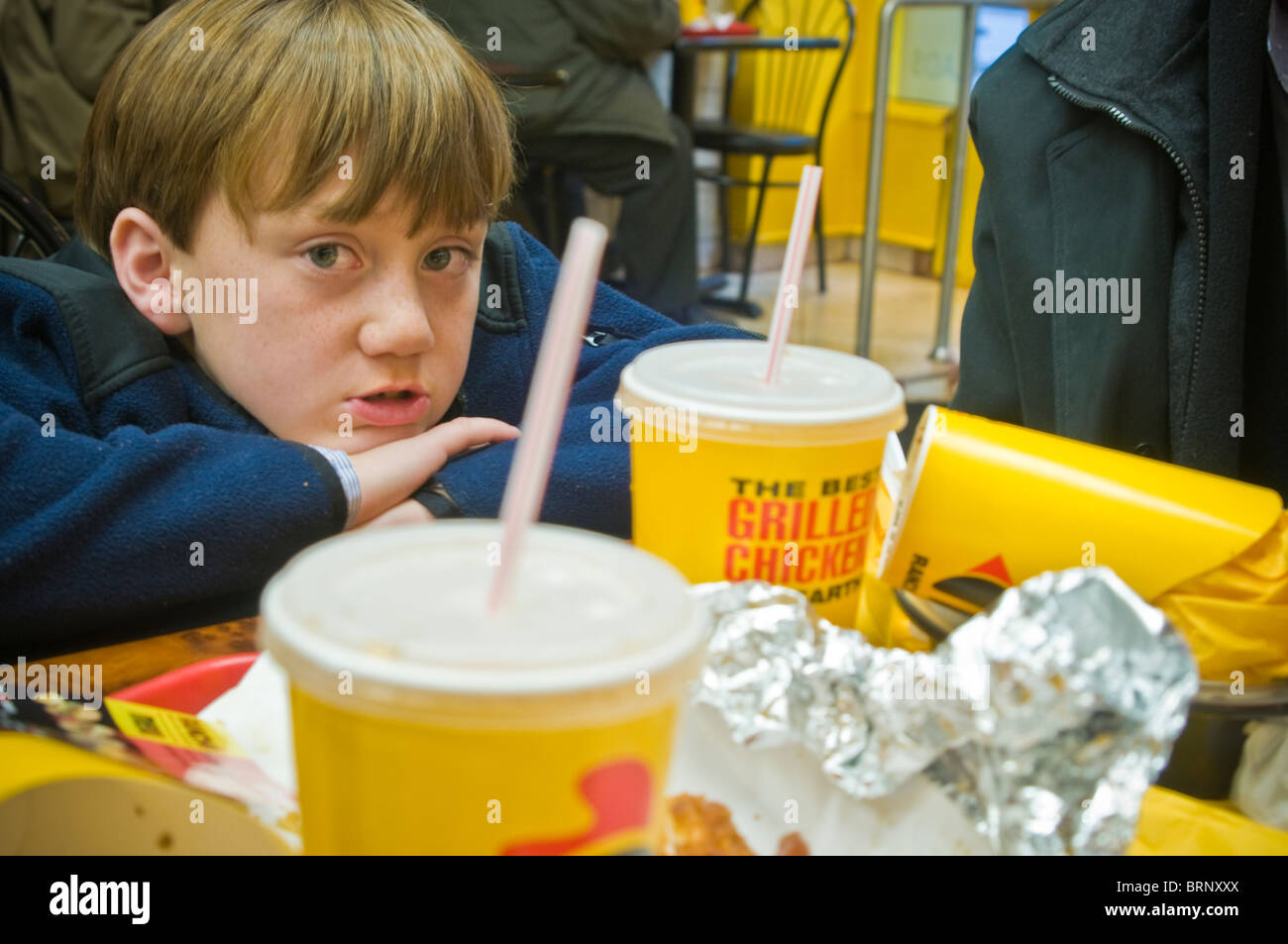One young boy at fast food restaurant table Stock Photo - Alamy