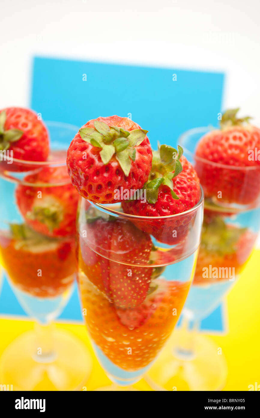 Champagne flutes containing champagne and strawberries, close-up Stock ...