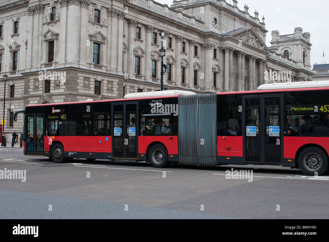 Transport for London red bendy bus, turning the corner from Parliament ...