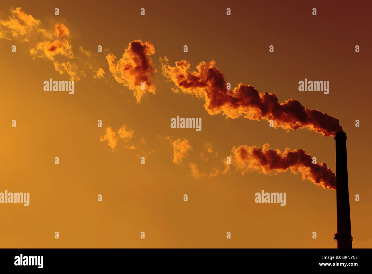 Industrial smokestacks at sunset Stock Photo - Alamy