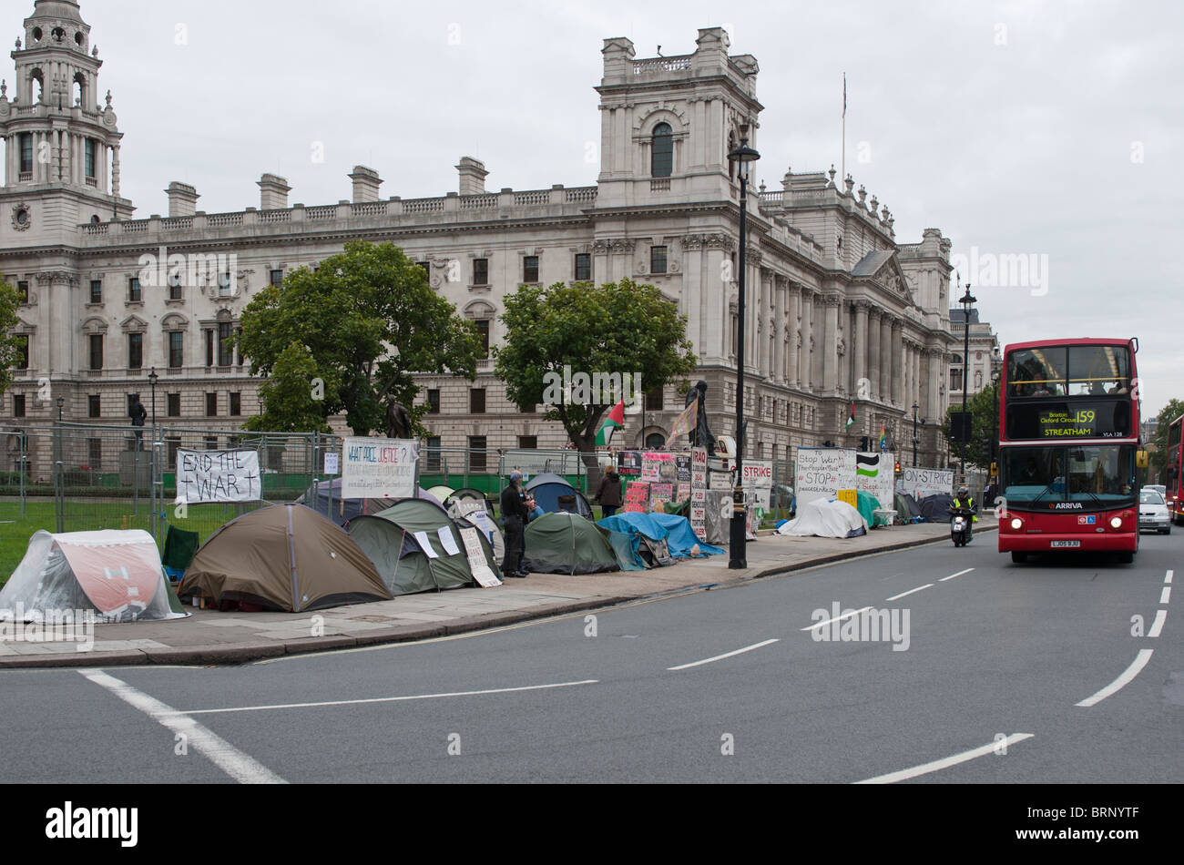 Red London Bus drives past peace protesters from the "peace strike ...