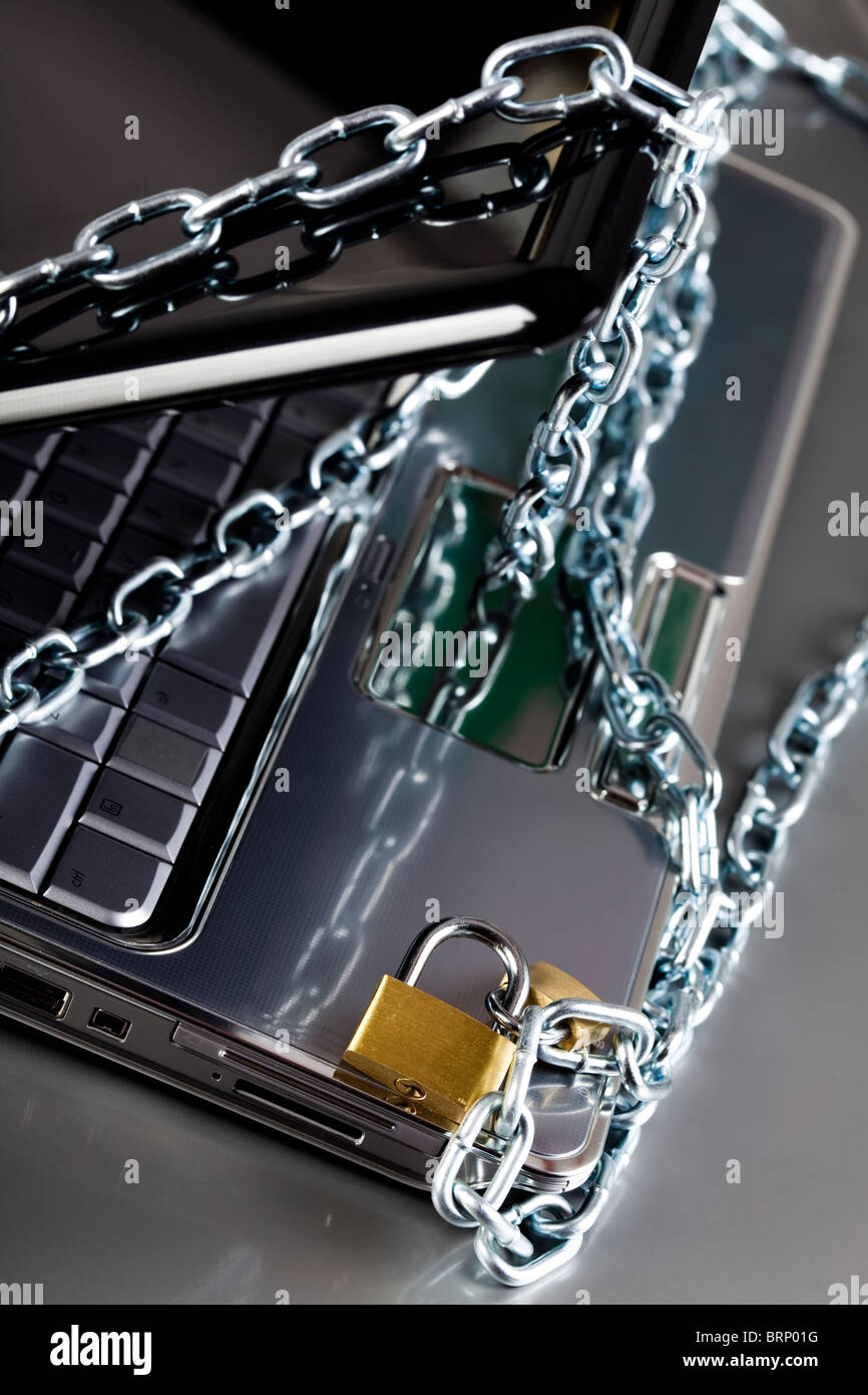 Laptop with chains Stock Photo - Alamy