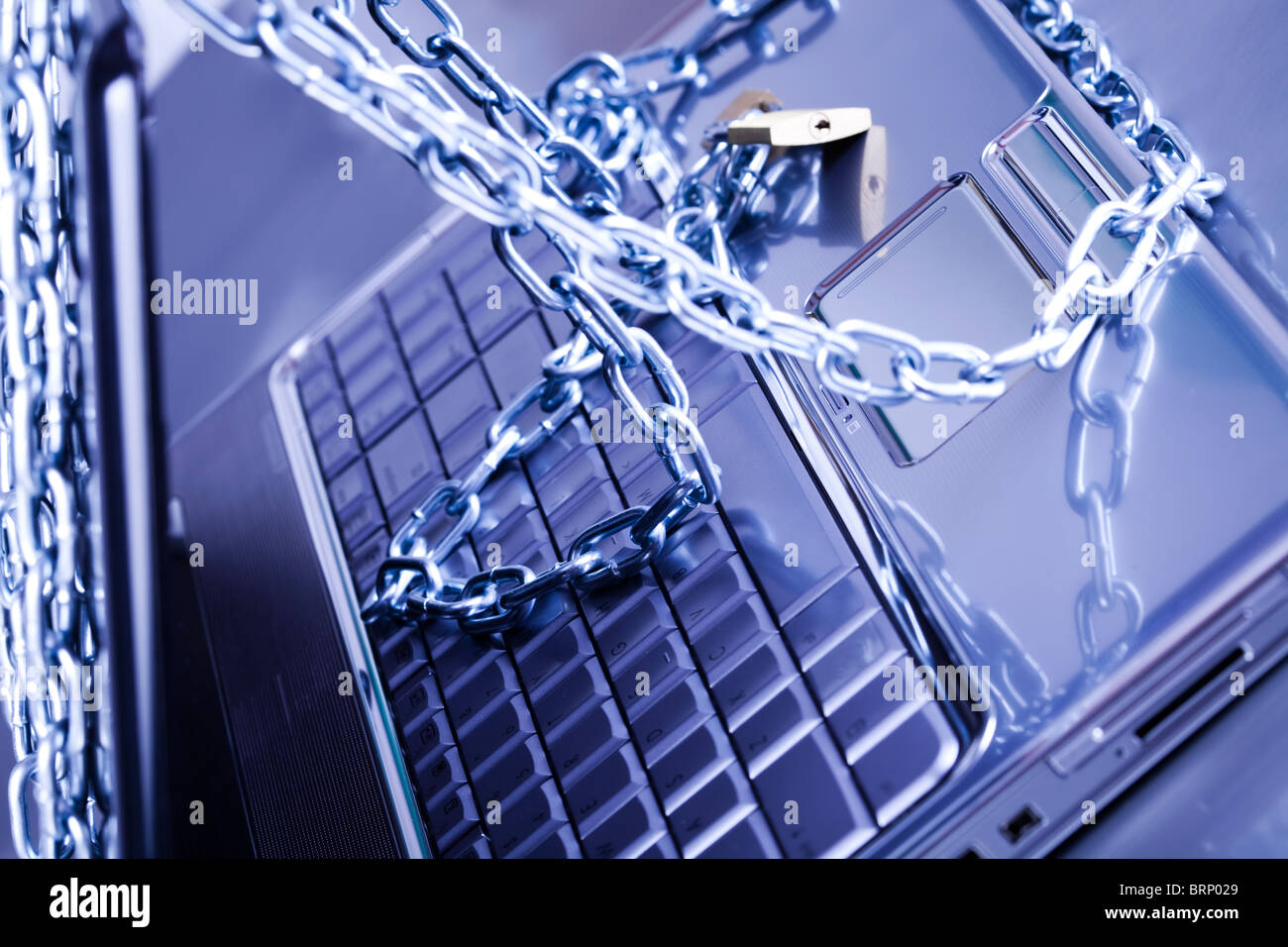Laptop with chains Stock Photo - Alamy