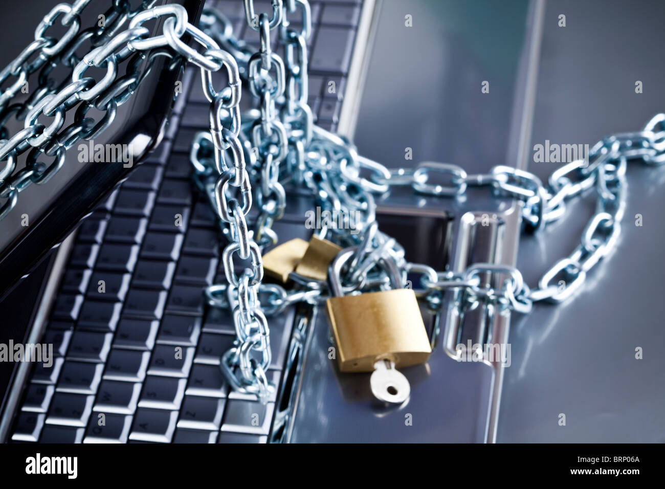 Laptop with chains Stock Photo - Alamy