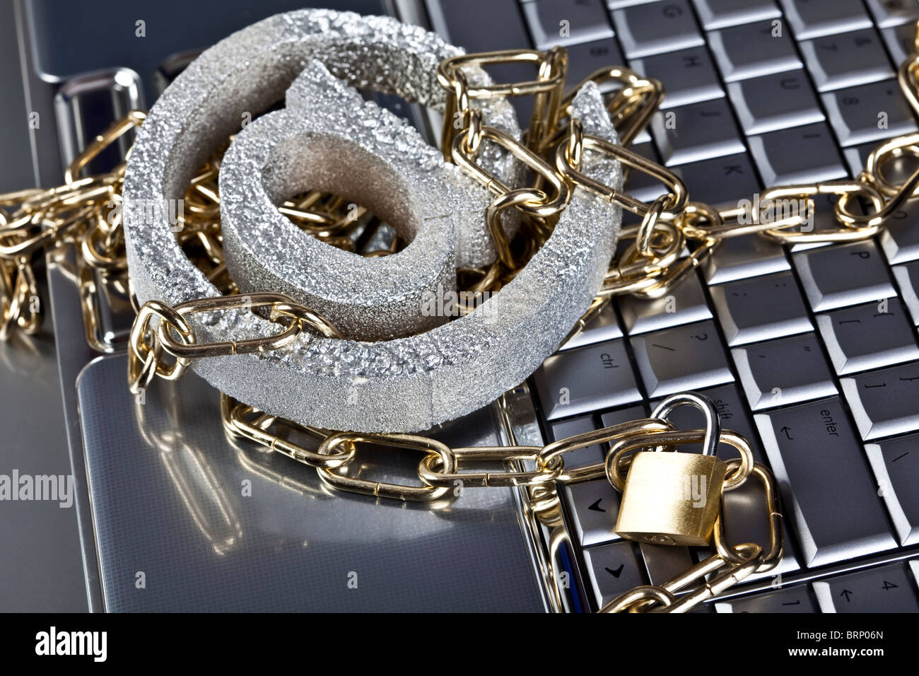 Laptop with chains Stock Photo - Alamy