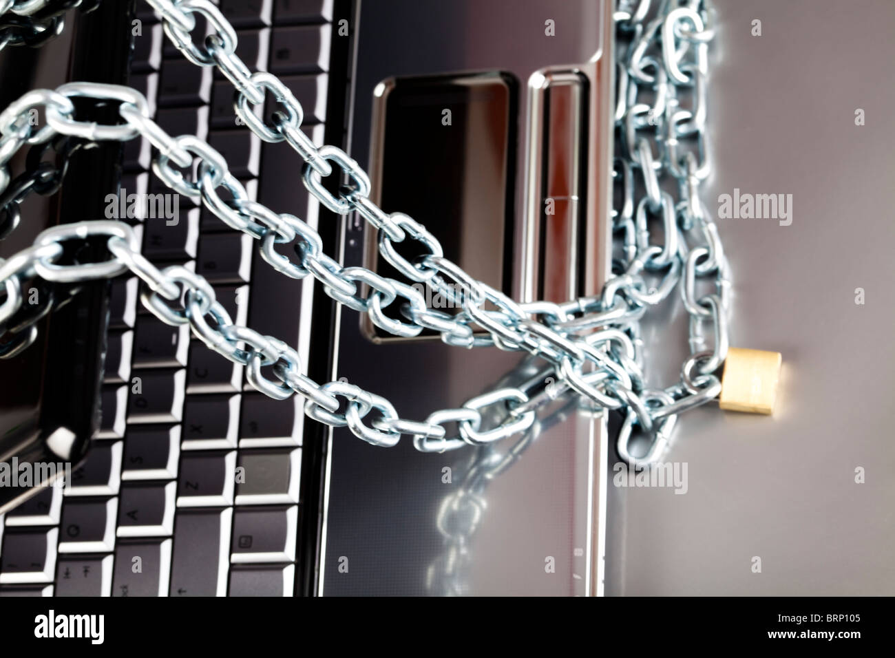 Laptop with chains Stock Photo - Alamy