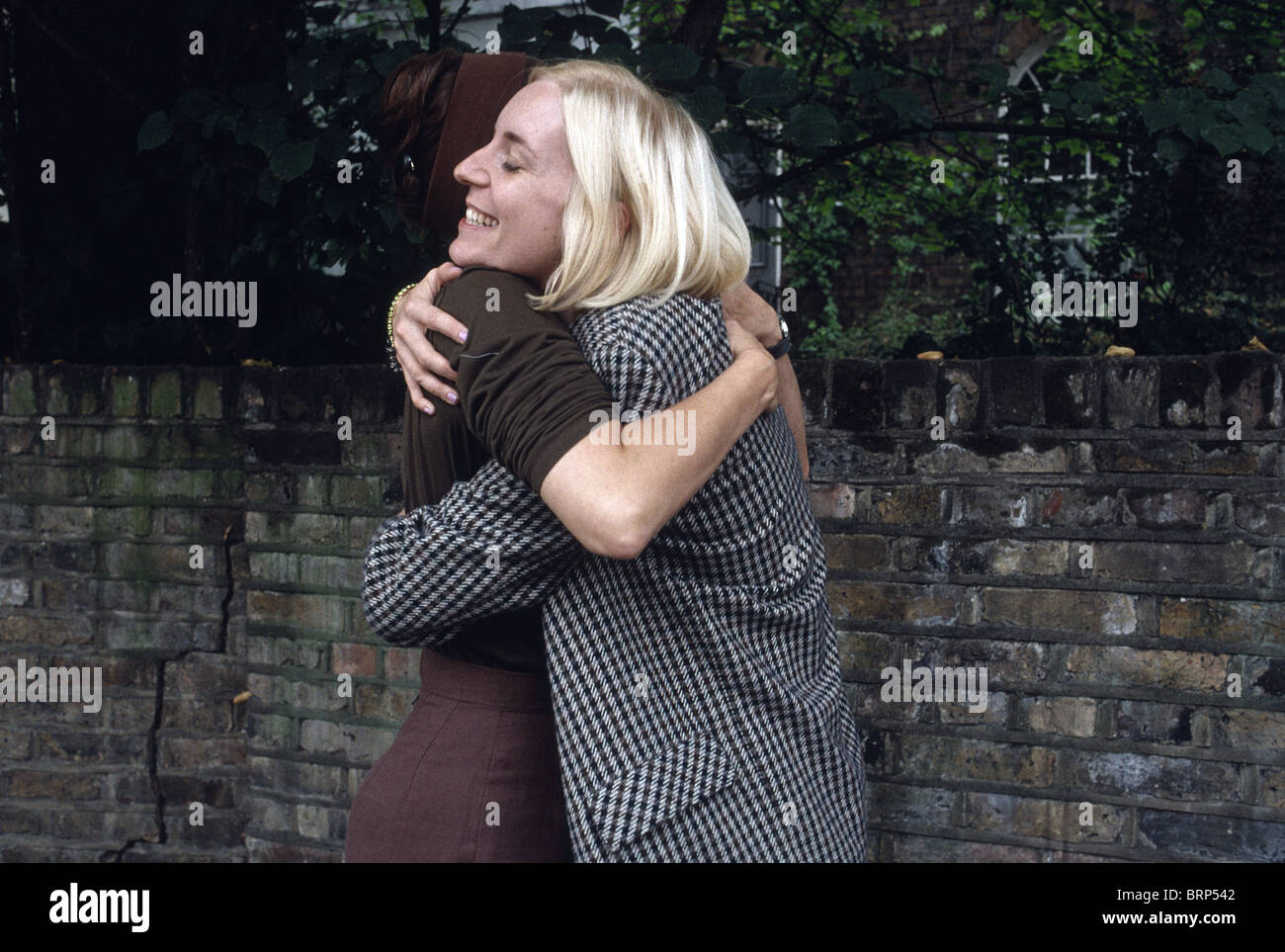 two good friends greeting and hugging Stock Photo - Alamy
