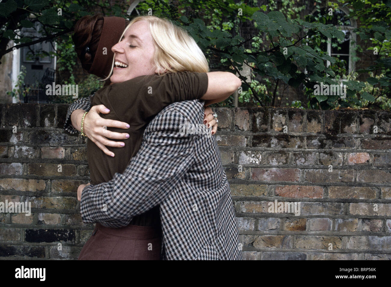 two good friends greeting and hugging Stock Photo - Alamy