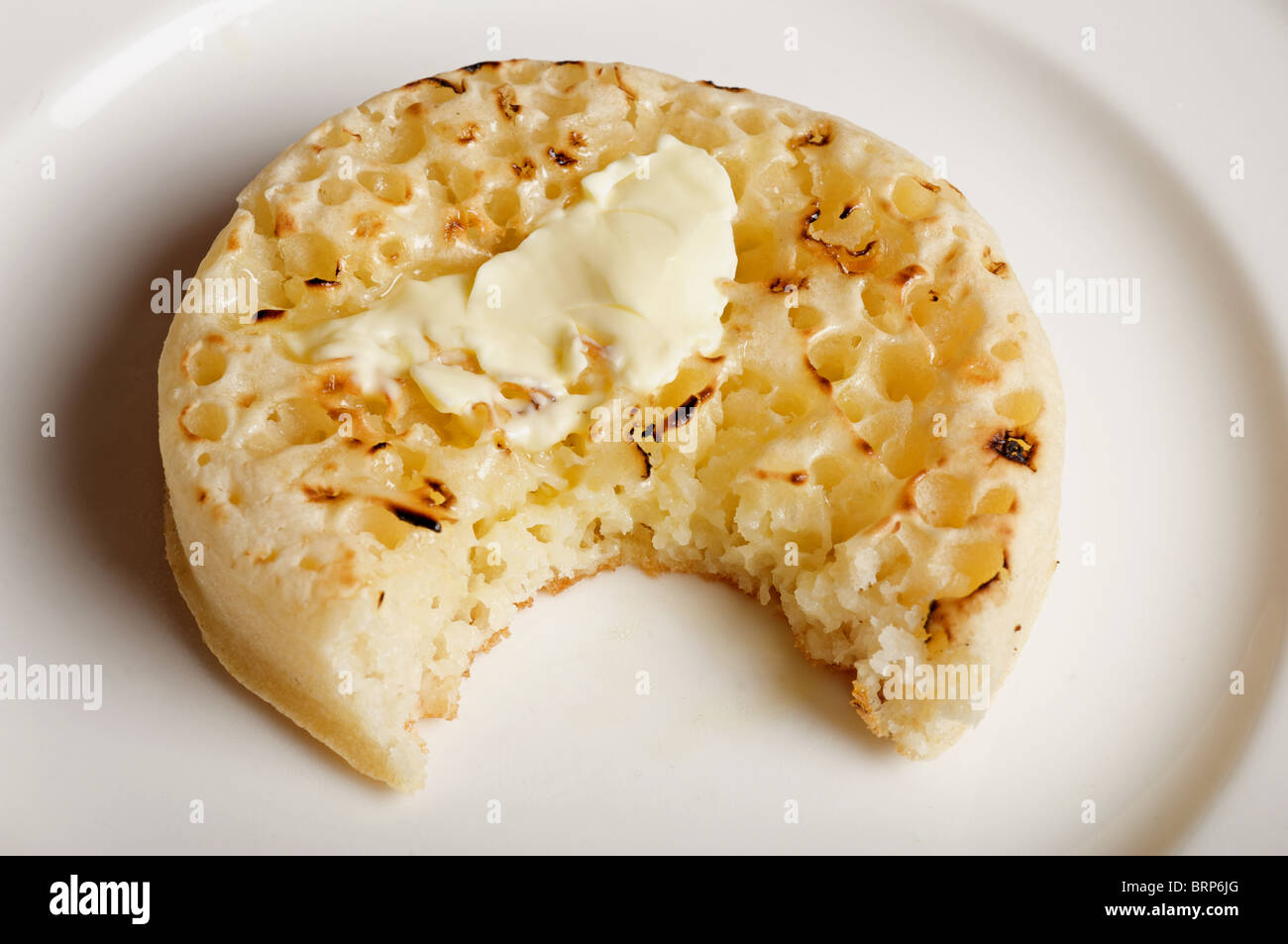 Toasted buttered crumpet Stock Photo - Alamy