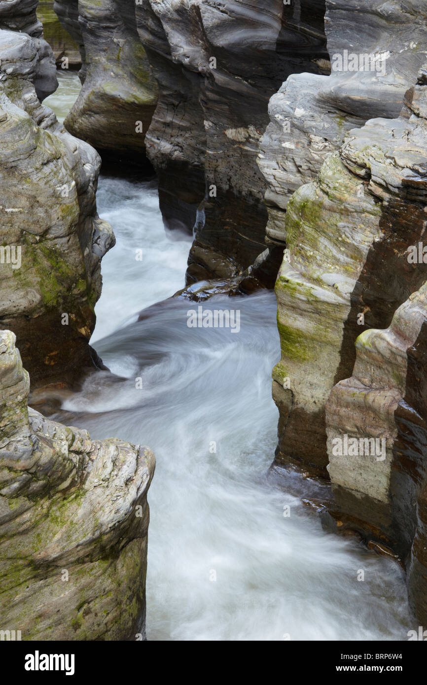 Rocks sculpted by the River Dee as it is forced through a narrow gorge ...