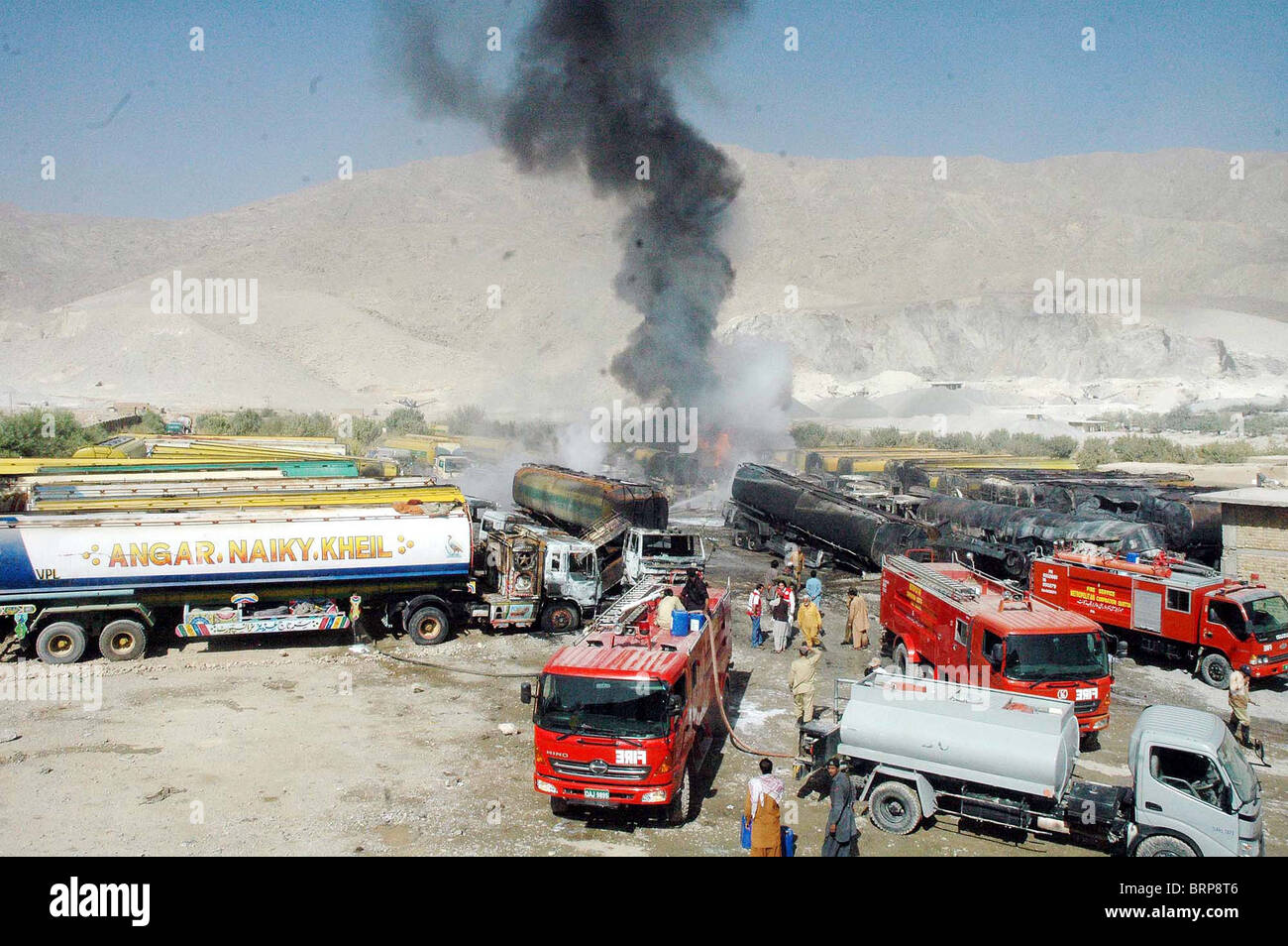 Fire tenders gather at the site following armed attack on NATO oil ...