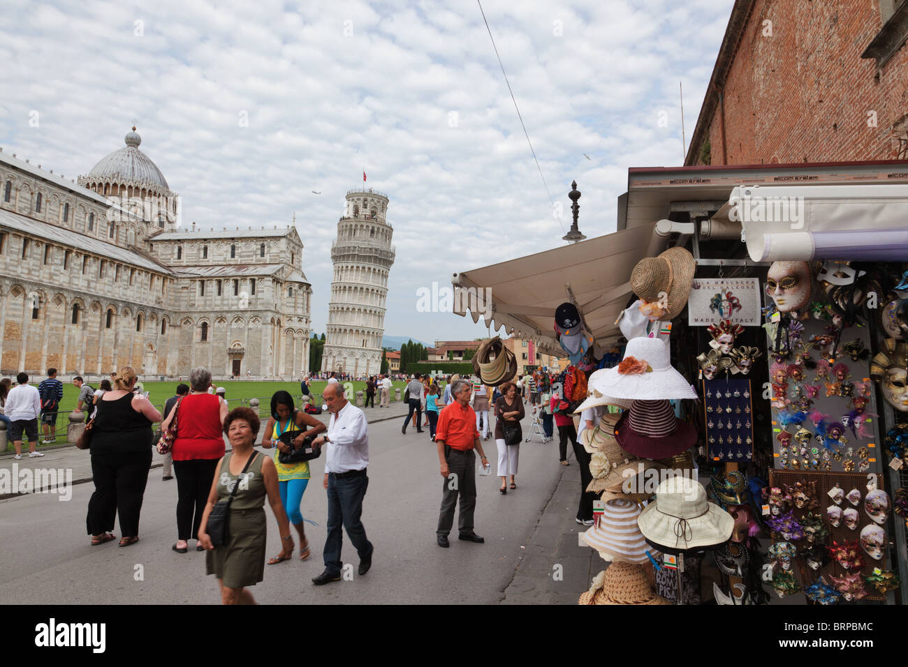 Tourists in Piazza del Duomo with Leaning tower of Pisa in background ...