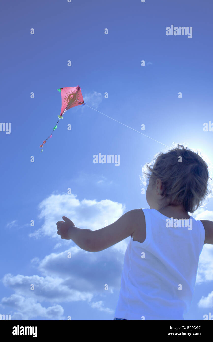Young boy flying a kite Stock Photo - Alamy