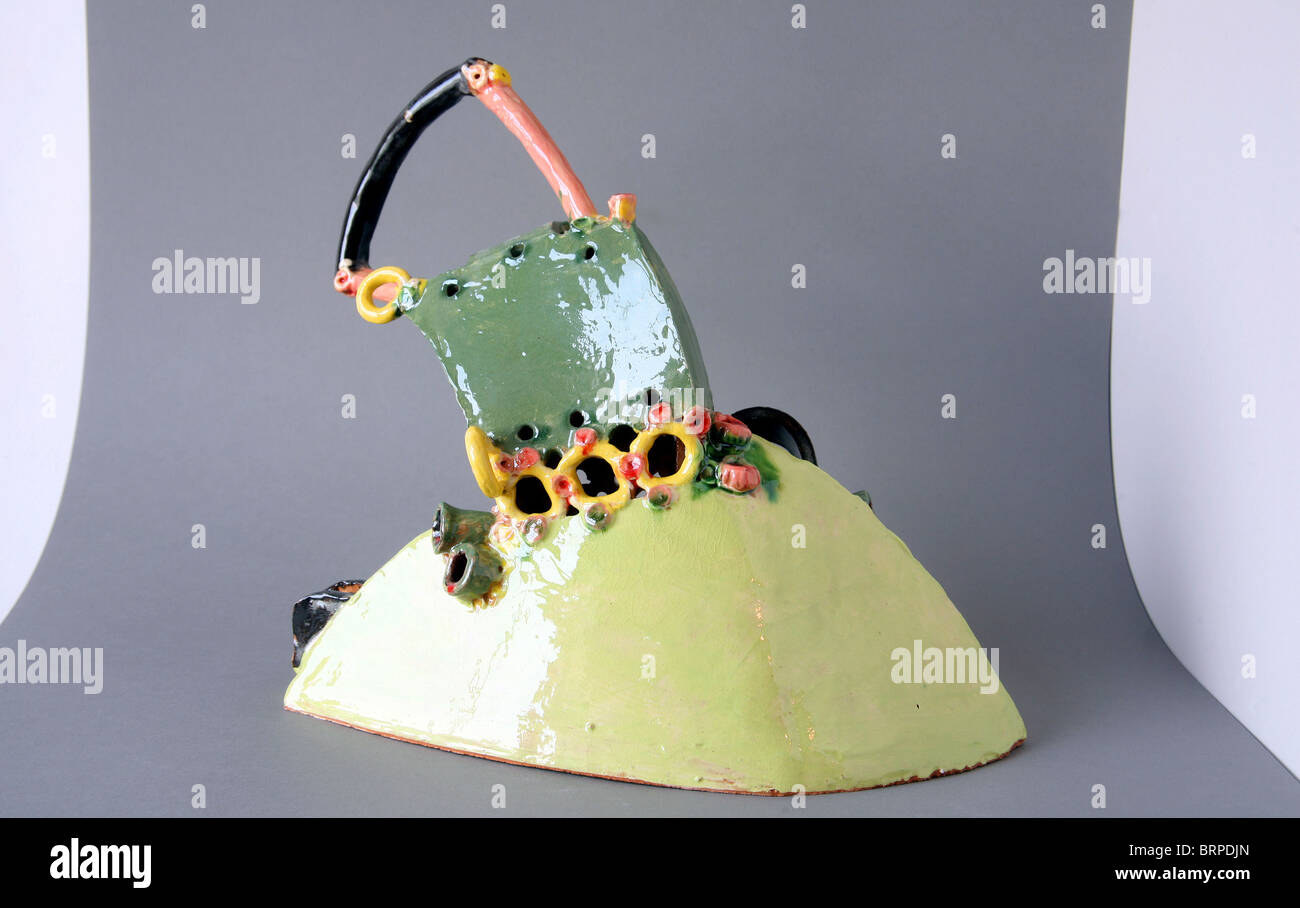 Ceramic iron by artist Paul Roche as objet d'art on gray background ...