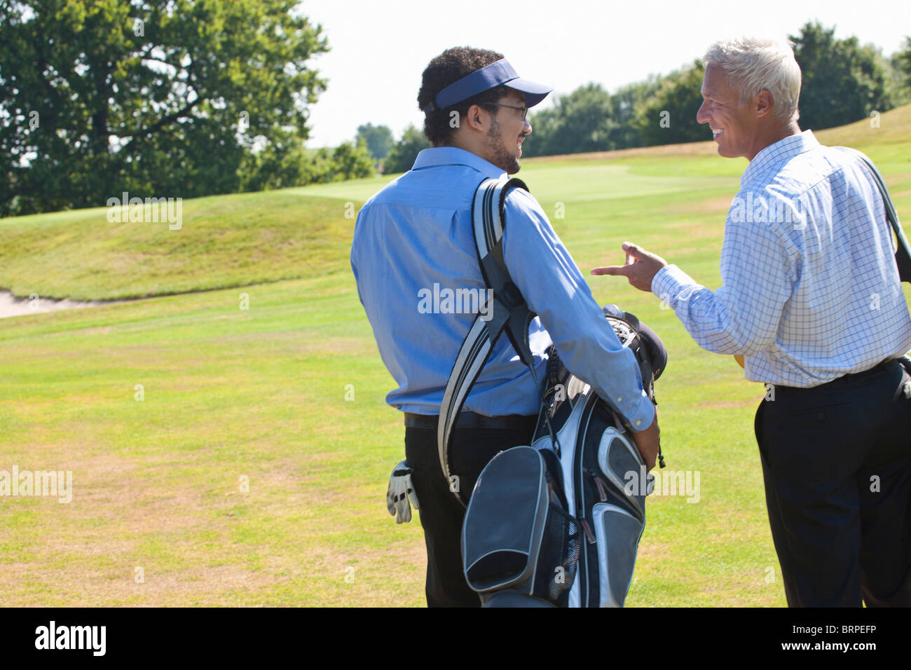 Golfers talking during the game Stock Photo - Alamy