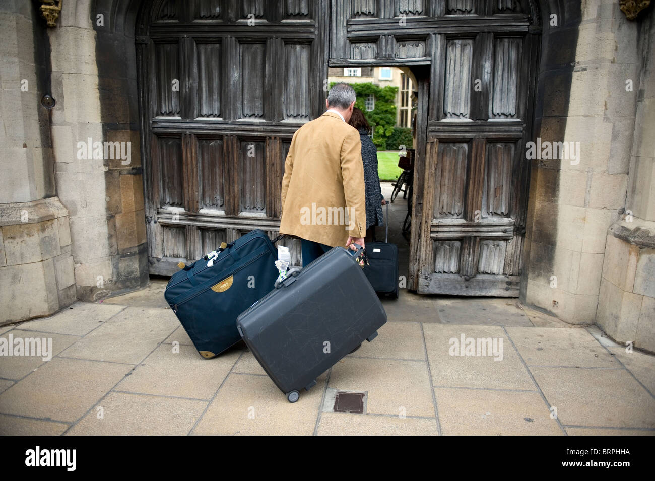 Cambridge University. Parents help carry bags for their student sons ...