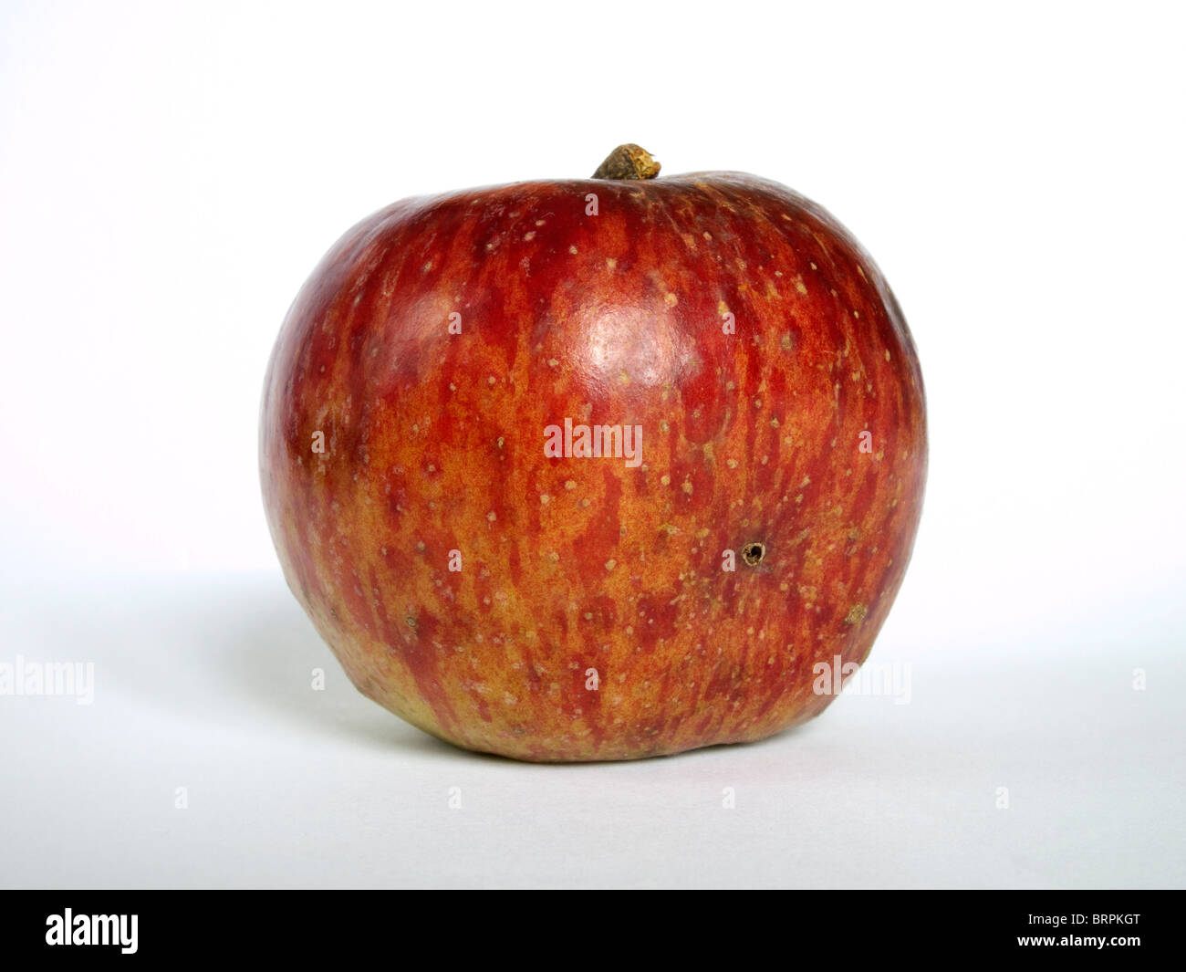 Red apple with hole Stock Photo - Alamy