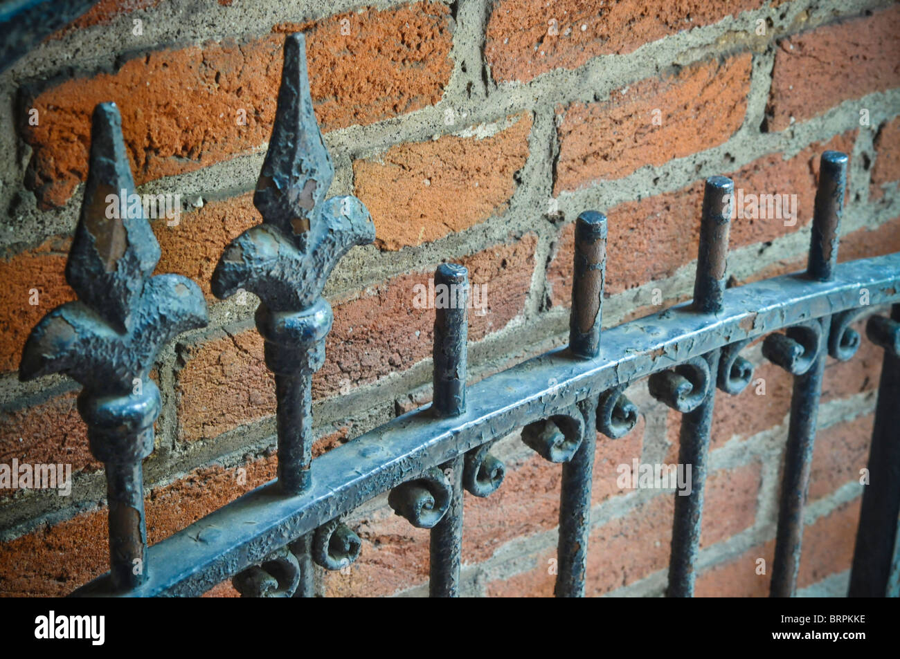 wrought iron fence ornamental bar stars brick Stock Photo - Alamy